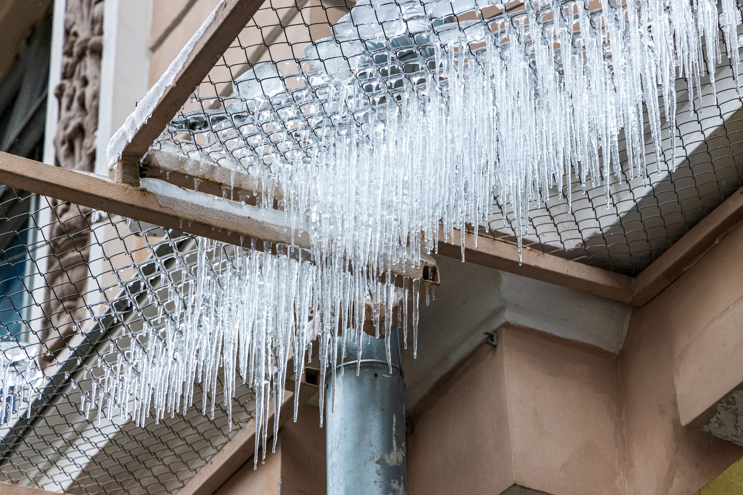 The Impact of Gutter Screens on Icicles and Ice Dams - Weather Vane Roofing